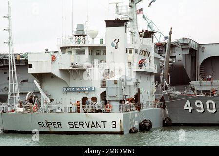 The ocean minesweeper USS LEADER (MSO-490) is moored to the submerged ...
