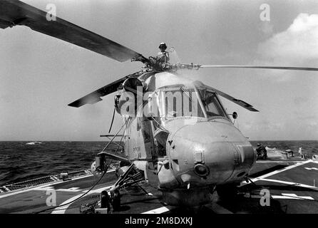 A squadron member hoses down a Helicopter Light Anti-submarine Squadron ...