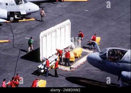 Aviation ordnancemen move a weapons skid containing four AIM-7 Sparrow ...