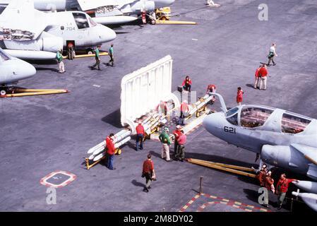 Aviation ordnancemen use an Aero 21A weapons skid to move AIM-9 ...
