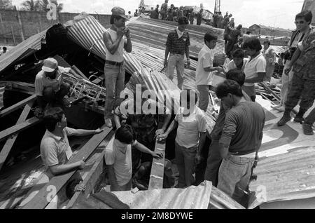 Rescue workers, assisted by members of a United States Marine ...