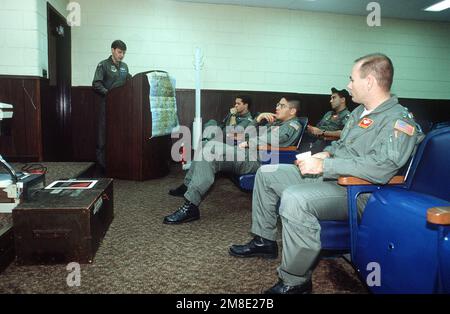 A pilot of the 345th Tactical Airlift Squadron looks over mission ...