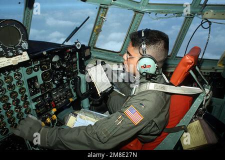 A pilot of the 345th Tactical Airlift Squadron looks over mission ...
