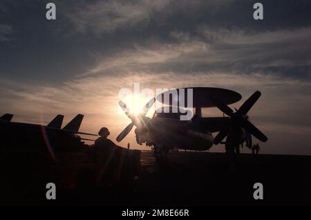 Aircraft handlers use an MD-3A tow tractor to respot a Carrier Airborne ...
