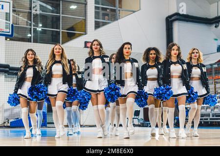 Cheerleaders in mini-skirts and knee-high socks holding pom-poms focus ...