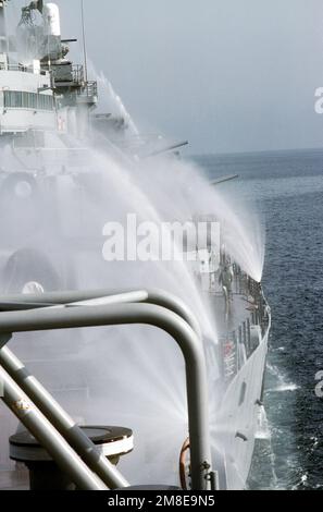 The topside areas of the battleship USS WISCONSIN (BB-64) are sprayed ...