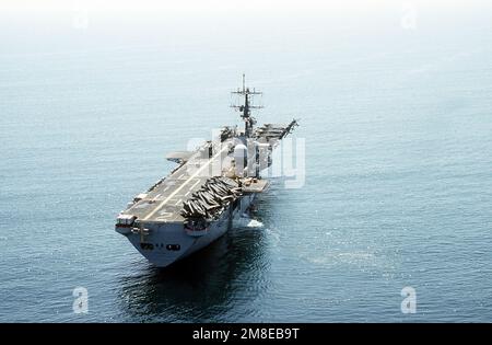 Various helicopters line the deck of the amphibious assault ship USS ...