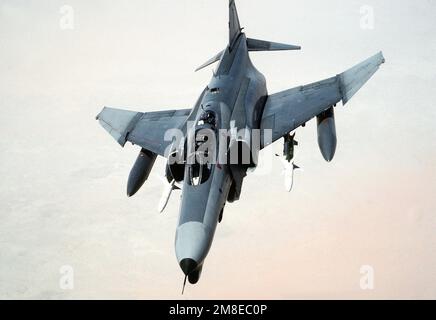 A 35th Tactical Fighter Wing F-4G Phantom II aircraft banks to the left ...