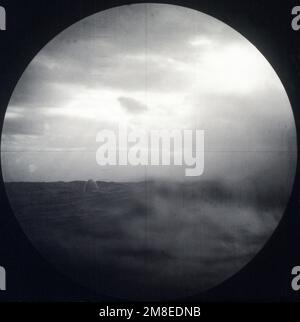 As seen through the submarine's periscope, a BGM-109 Tomahawk land ...