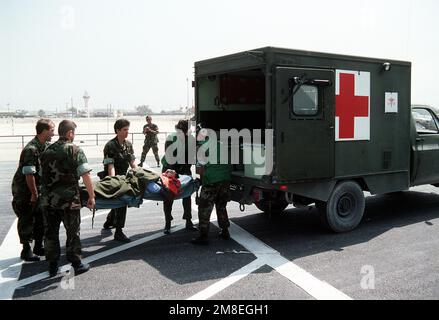 Litter bearers at Fleet Hospital Six carry a patient off of an Army UH ...