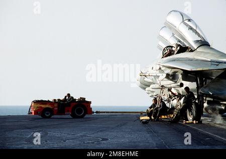 Aircraft handlers use an MD-3A tow tractor to respot a Carrier Airborne ...