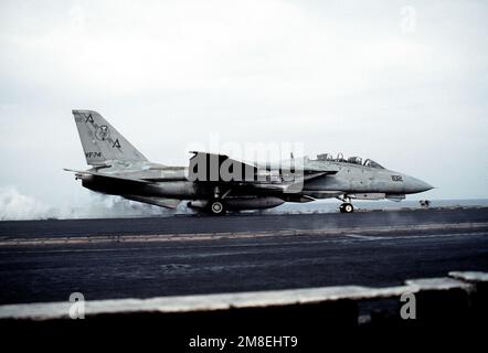 Fighter Squadron 74 (VF-74) F-14A Tomcat aircraft taxi on the flight deck of the aircraft ...