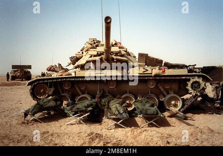 Marines work on the power pack from an M-60A1 tank at a camp in ...