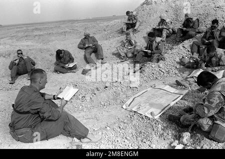 Members of the 3rd Tank Battalion, 1ST Marine Division, stand near a B ...
