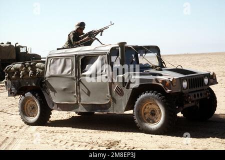 A Marine stands by an M998 High-Mobility Multipurpose Wheeled Vehicle ...
