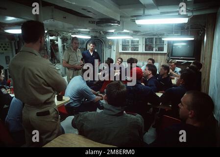 CAPT. Douglas C. Bauer, a Naval historian, speaks with the ship's ...