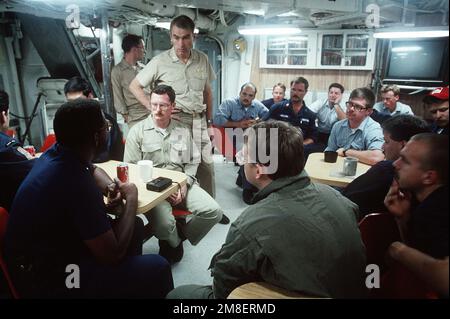 CAPT. Douglas C. Bauer, a Naval historian, speaks with the ship's ...