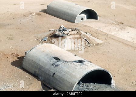 A view of damage to hardened aircraft shelters and concrete munitions ...