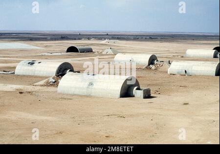 A view of damage to concrete munitions bunkers and hardened aircraft ...