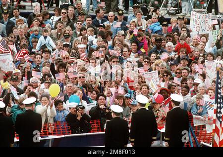 A crowd of well-wishers welcomes LT. Jeffrey Zaun, LT. Lawrence Slade ...