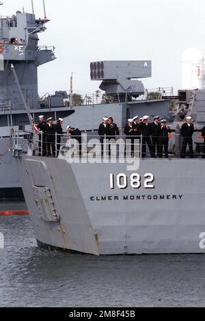 Crew members stand on the stern of the destroyer USS SPRUANCE (DD-963 ...