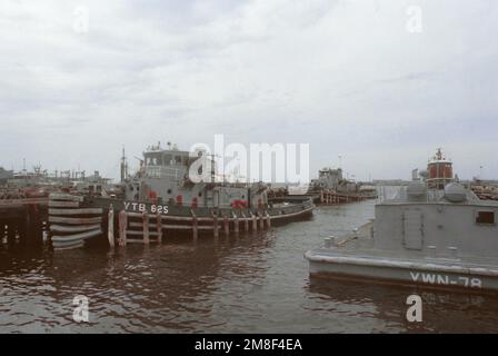 The large harbor tug WATHENA (YTB 825) maneuvers the battleship ...