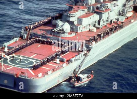 Crew members stand in formation at the start of the decommissioning ...