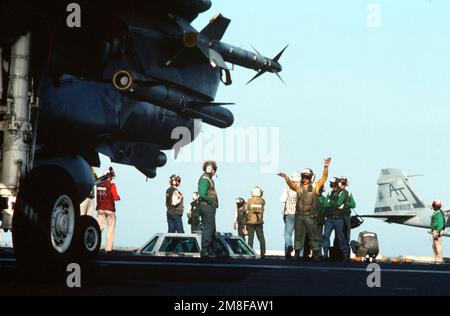 An aircraft handler aboard the nuclear-powered aircraft carrier USS ...