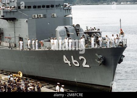 A band plays on the pier as the large harbor tug OPELIKA (YTB-798 ...