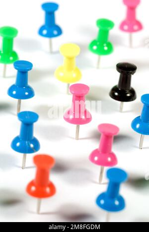 Push pins on white paper background Stock Photo - Alamy
