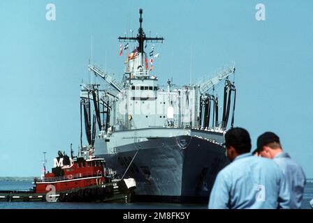 Line handlers stand by on the pier as the tank landing ship USS ...