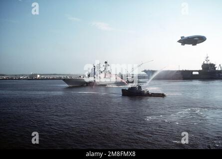 The large harbor tug CHESANING (YTB-769) sprays water in welcome as the ...
