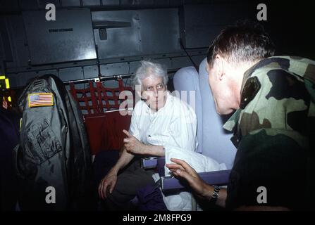 American hostage Edward Austin Tracy raises his arms to a crowd of well ...