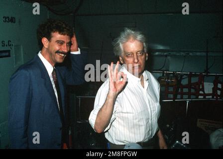 American hostage Edward Austin Tracy raises his arms to a crowd of well ...
