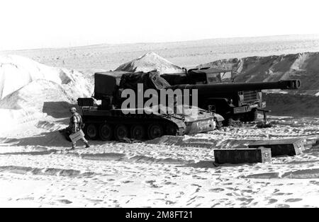 Marines from Btry. R, 5th Bn., 11th Marines, stand aboard their M-110A2 ...