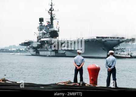 Line handlers stand by as the pier as the aircraft carrier USS ...