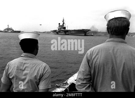 Line handlers stand by on the pier as the tank landing ship USS ...