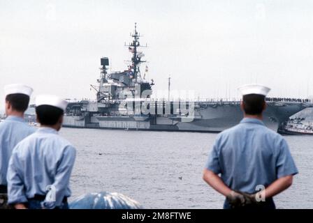 Line handlers stand by on the pier as the tank landing ship USS ...