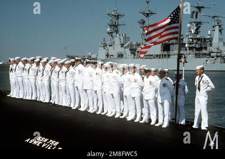 Officers and enlisted men stand at parade rest aboard the nuclear ...