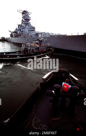 The large harbor tug WATHENA (YTB 825) maneuvers the battleship ...