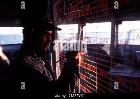 A crewman aboard the tank landing ship USS SUMTER (LST 1181) uses ...
