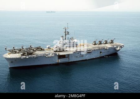 Various helicopters line the deck of the amphibious assault ship USS ...