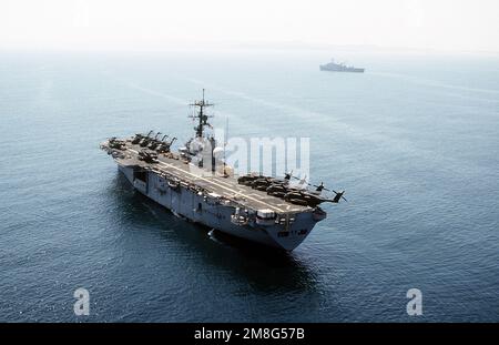 Various helicopters line the deck of the amphibious assault ship USS ...