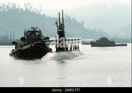 The large harbor tug NASHUA (YTB-774) moves into assist the tank ...