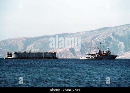 The salvage and rescue ship USS BRUNSWICK (ATS-3) tows the small ...
