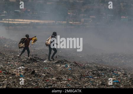 Waste pickers recover waste for recycling amidst heavy smoke from ...