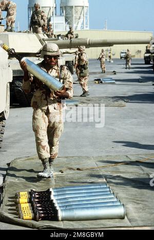 An ammunition specialist carries a 105mm armor-piercing, discarding ...