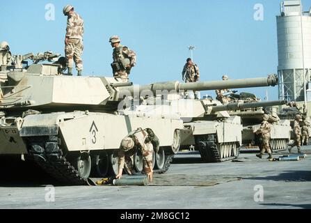 Soldiers load M-1 Abrams main battle tanks with supplies prior to a ...