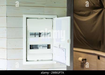 automatic fuses in electricity distribution box (fusebox) inside wooden ...