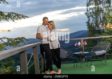 Horizontal sideview shot of a young couple in summer outfit enjoying ...